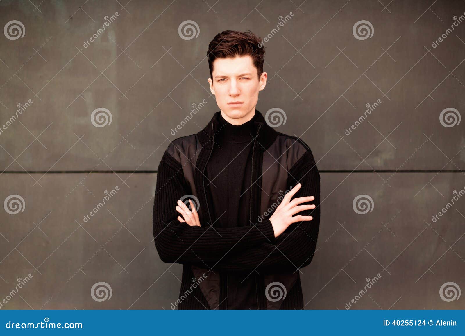 The Young Man Model in a Black Jacket Poses at a Wall. Image Toned ...