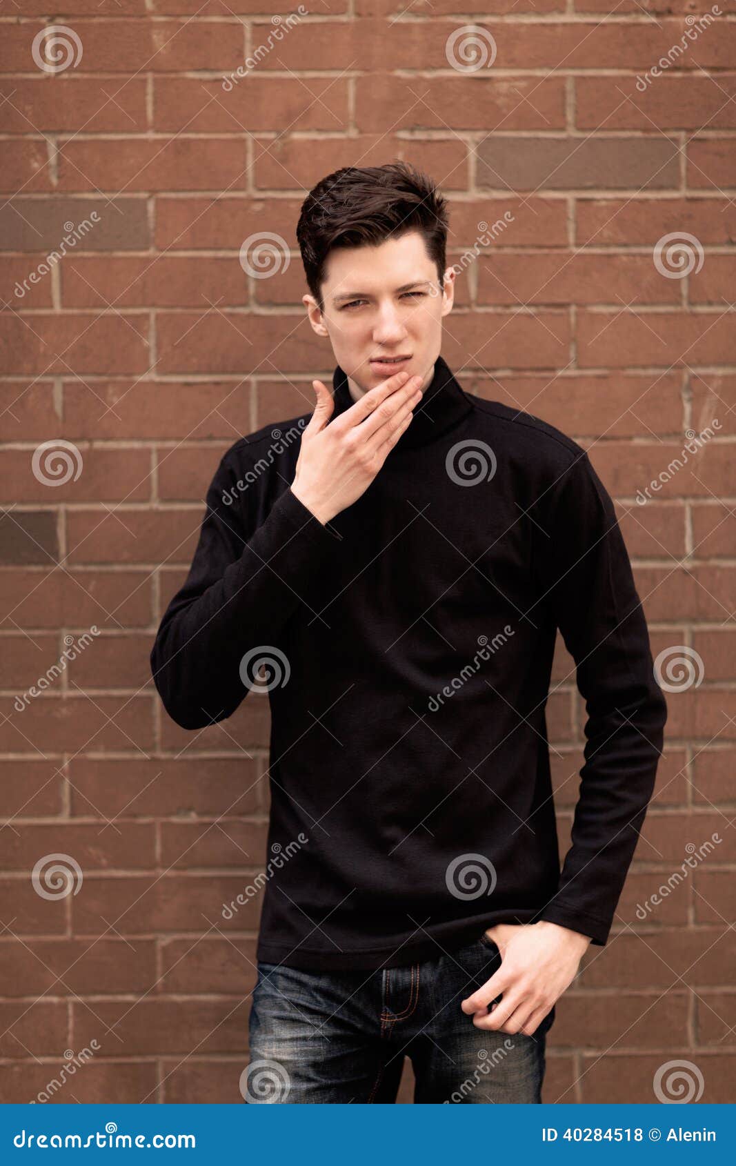 The Young Man Model Poses at a Brick Wall. Toned Stock Photo - Image of ...
