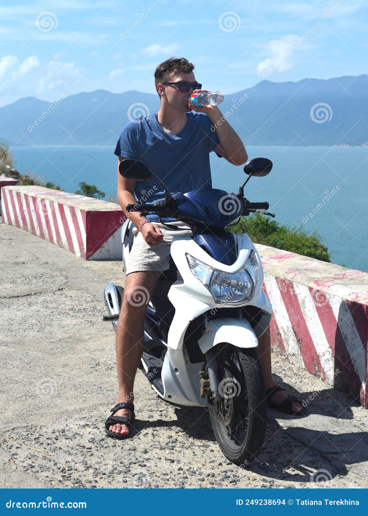 Young Man a Motorbike Driver Drinking Water from a Plastic Bottle Stock ...