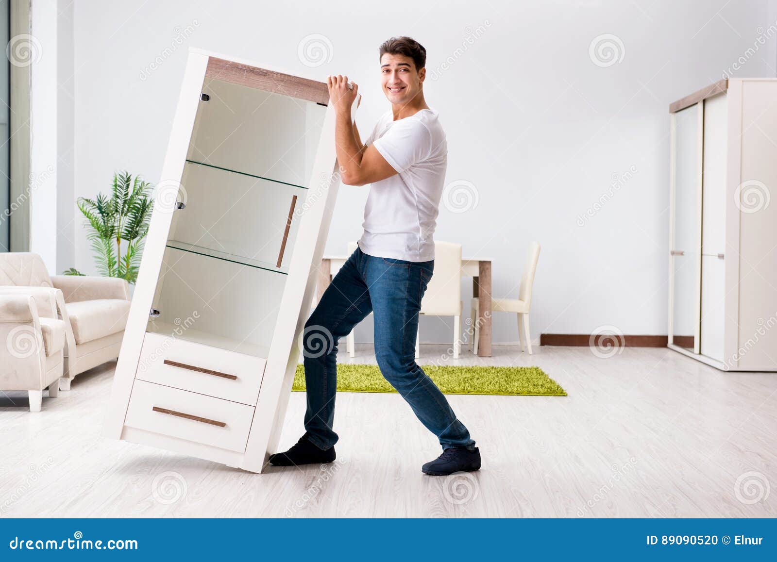 The Young Man Moving Furniture at Home Stock Photo - Image of cabinet ...