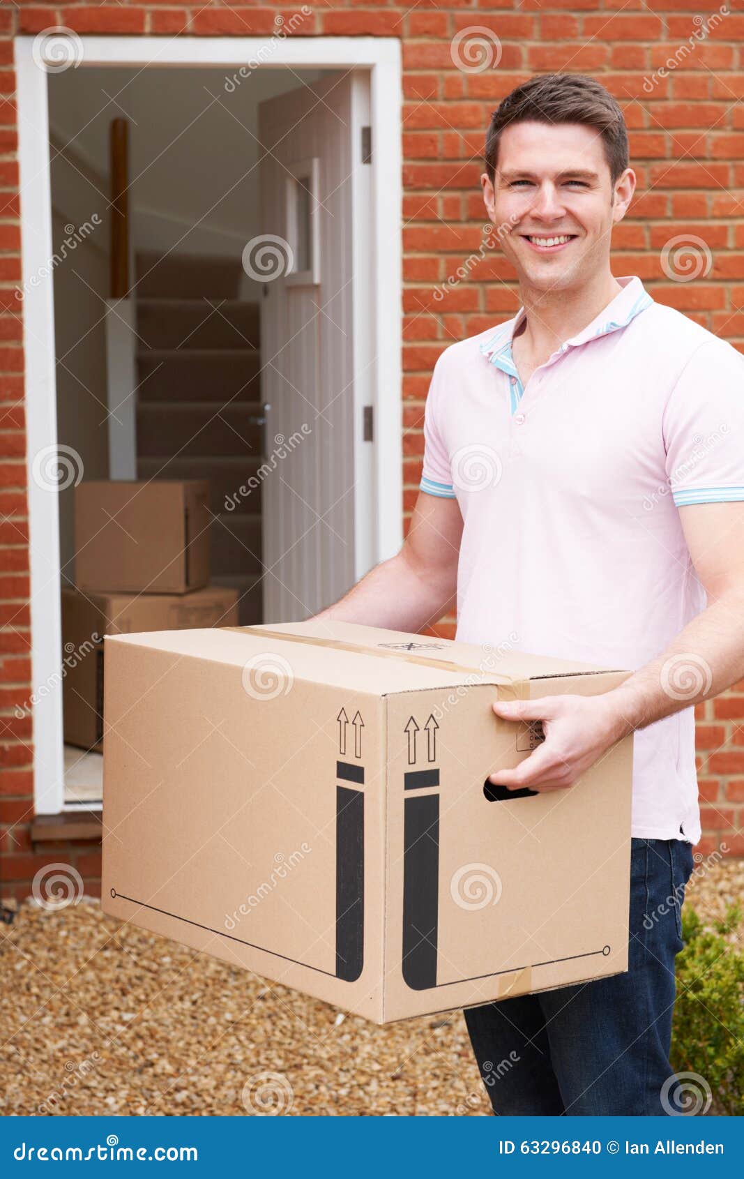 Young Man Moving into New Home Stock Photo - Image of happy, smiling ...