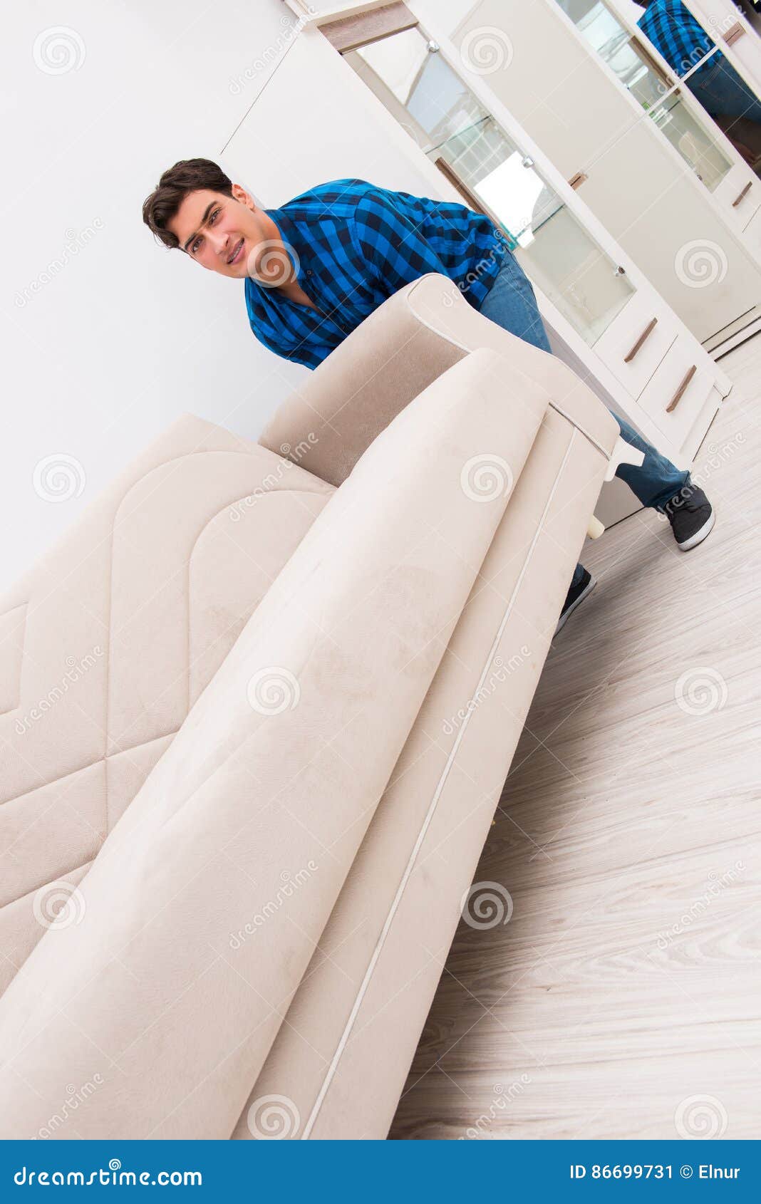 The Young Man Moving Sofa Couch Stock Image - Image of couch, male ...