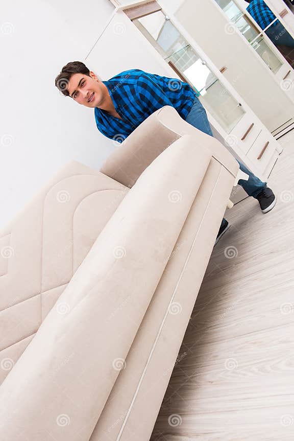 The Young Man Moving Sofa Couch Stock Image - Image of couch, male ...
