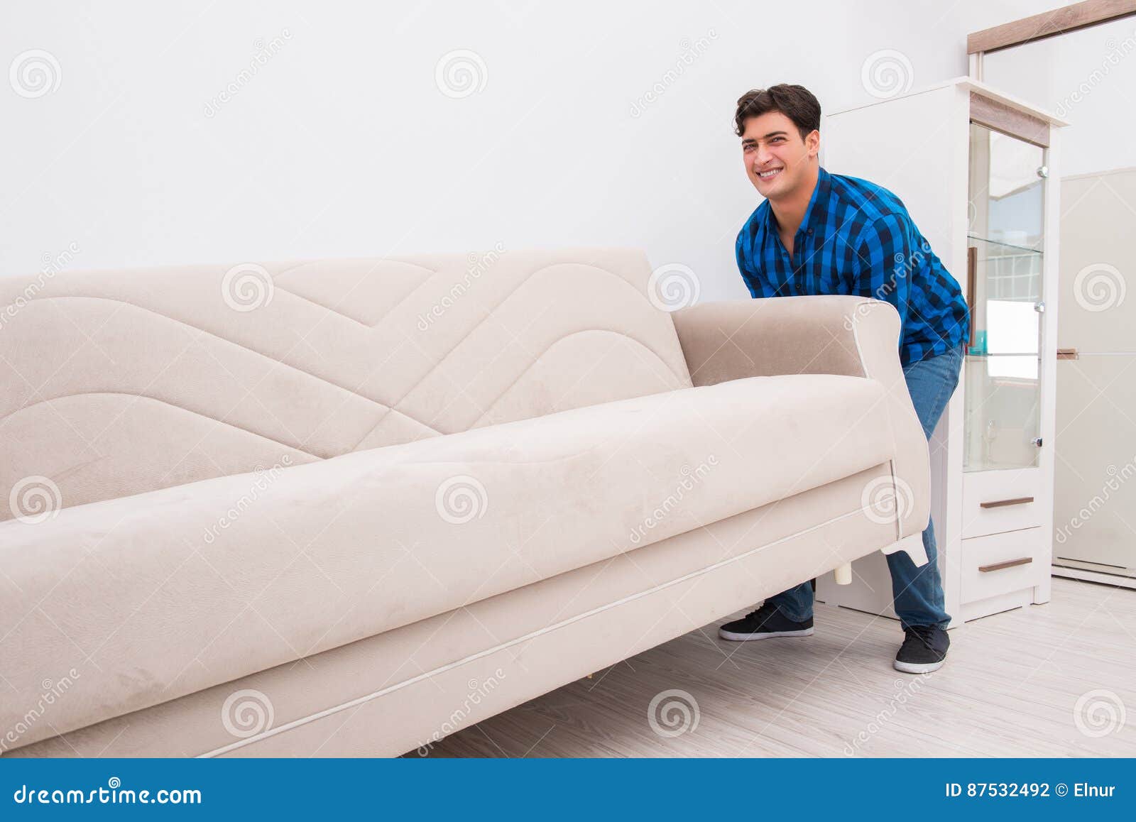 The Young Man Moving Sofa Couch Stock Photo - Image of casual, pain ...