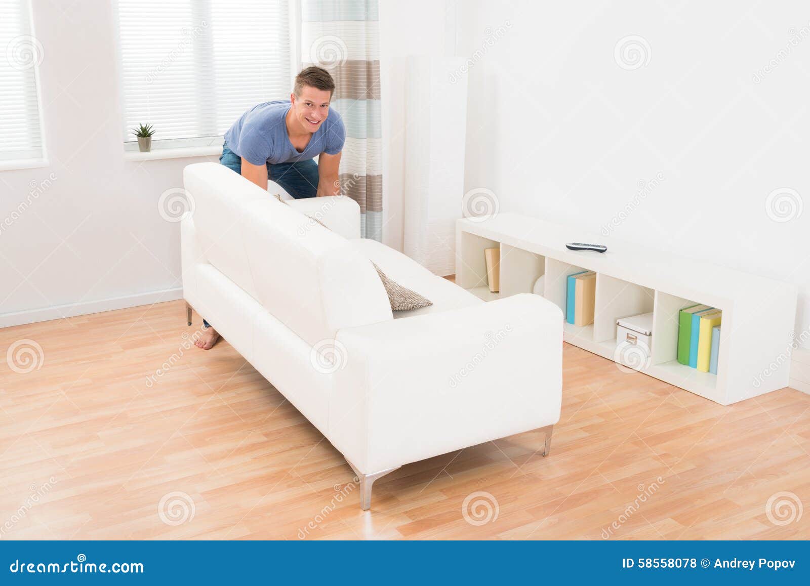 Young Man Moving Sofa stock photo. Image of individuality - 58558078
