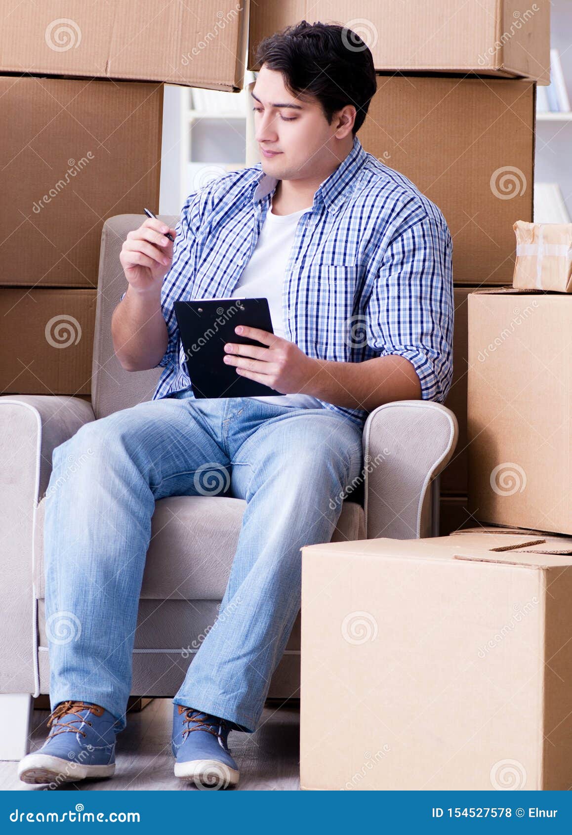 Young Man Moving in To New House with Boxes Stock Photo - Image of ...