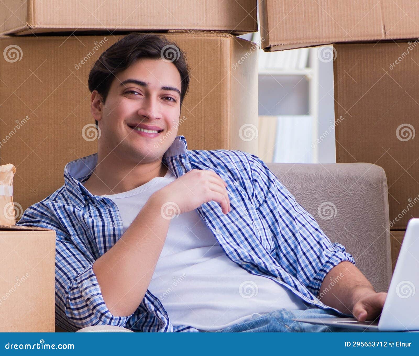 Young Man Moving in To New House with Boxes Stock Photo - Image of ...