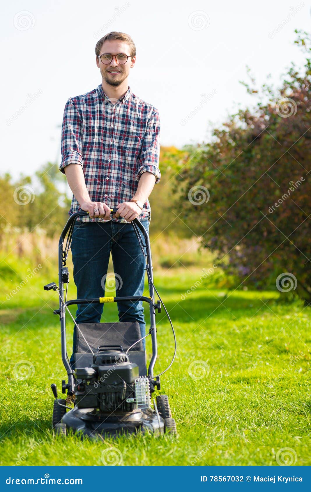 Young man mowing the grass stock photo. Image of cutter - 78567032