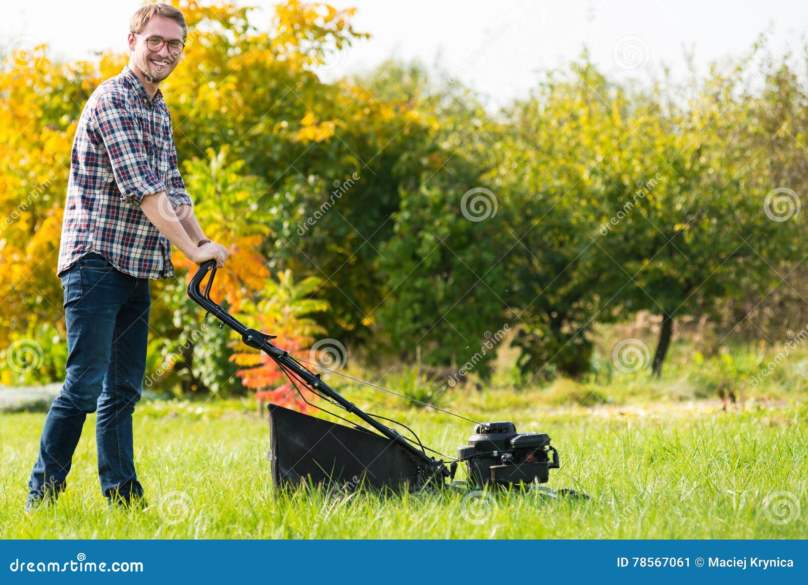 Young man mowing the grass stock image. Image of field - 78567061