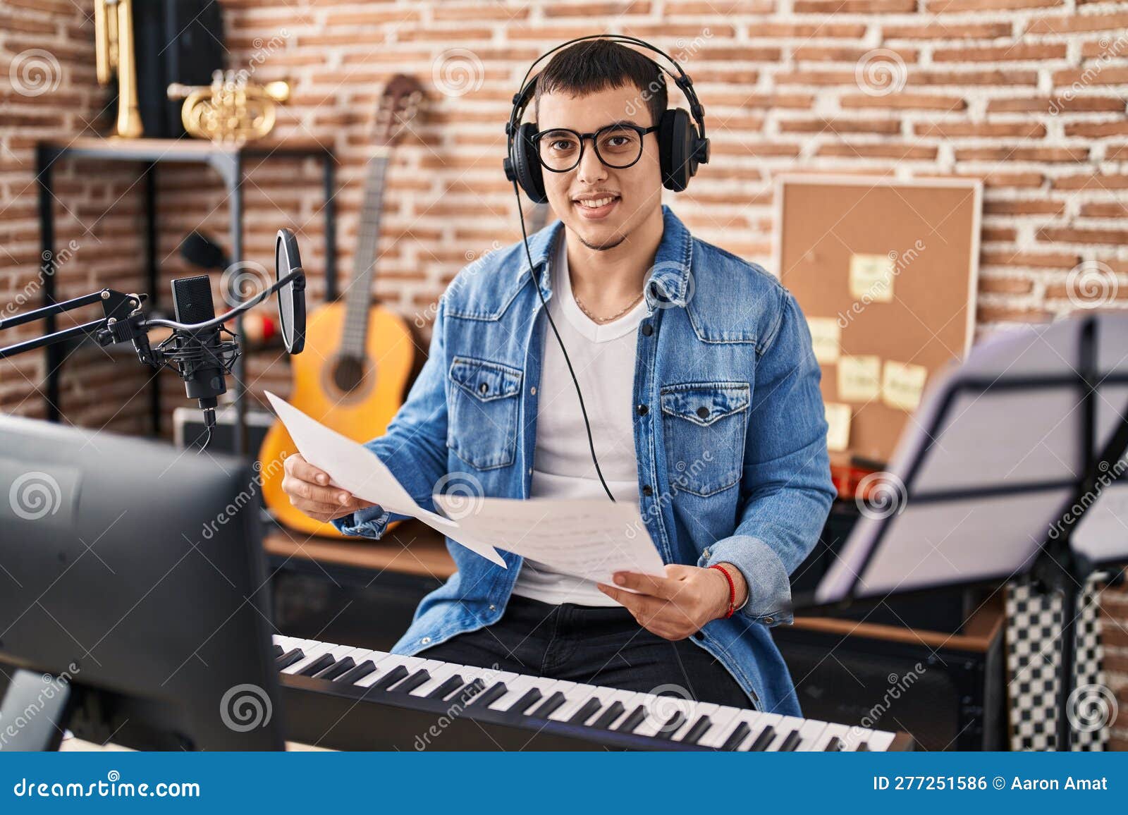 Young Man Musician Holding Music Sheet at Music Studio Stock Photo ...