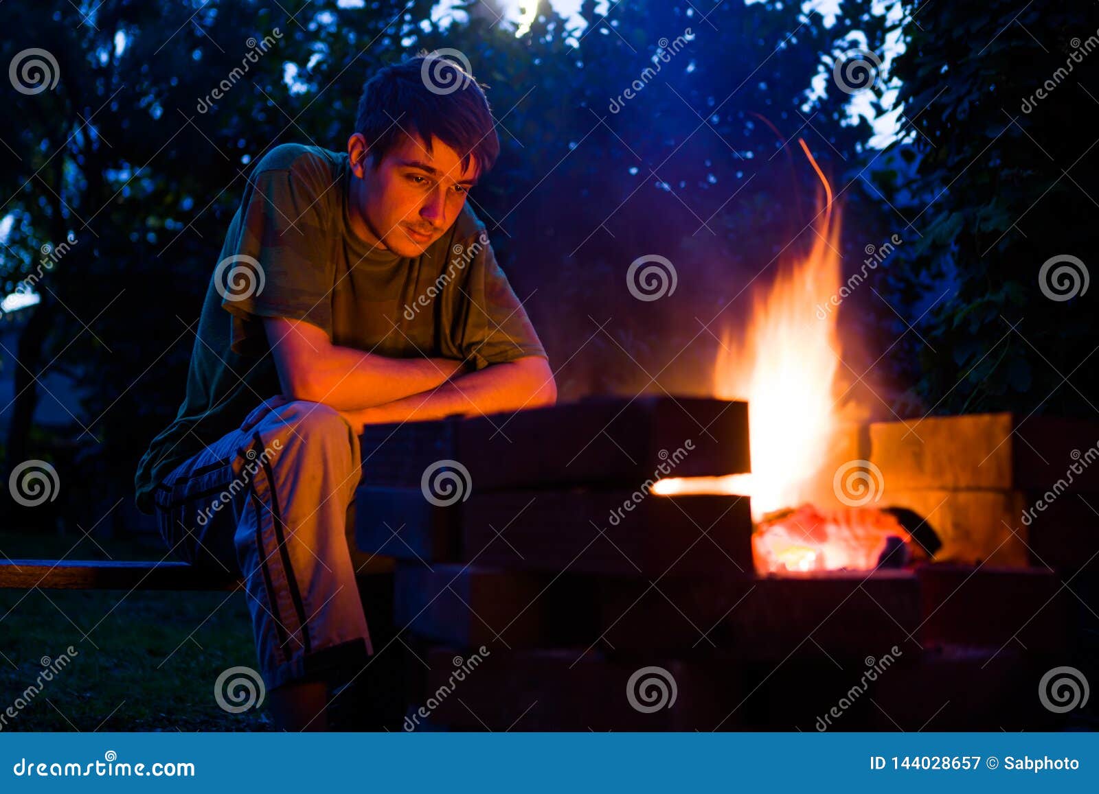 Young Man near the Fire stock image. Image of face, adult - 144028657