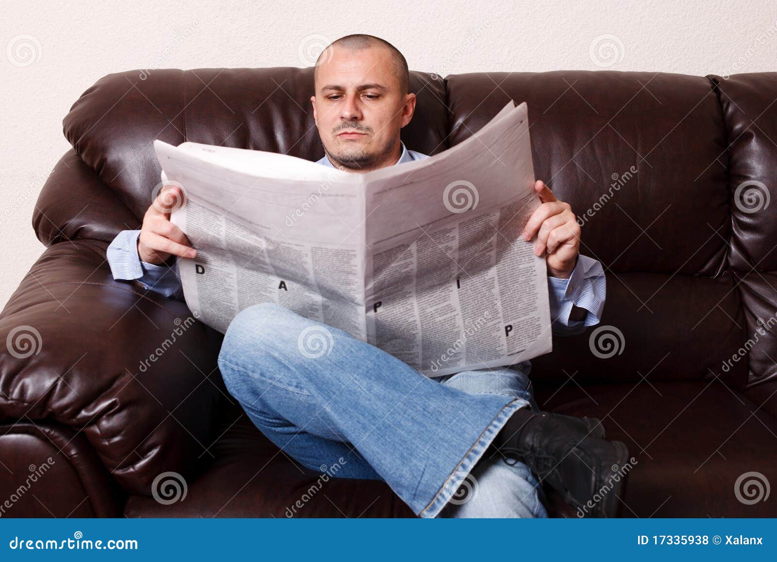 Young man with newspaper stock photo. Image of leisure - 17335938