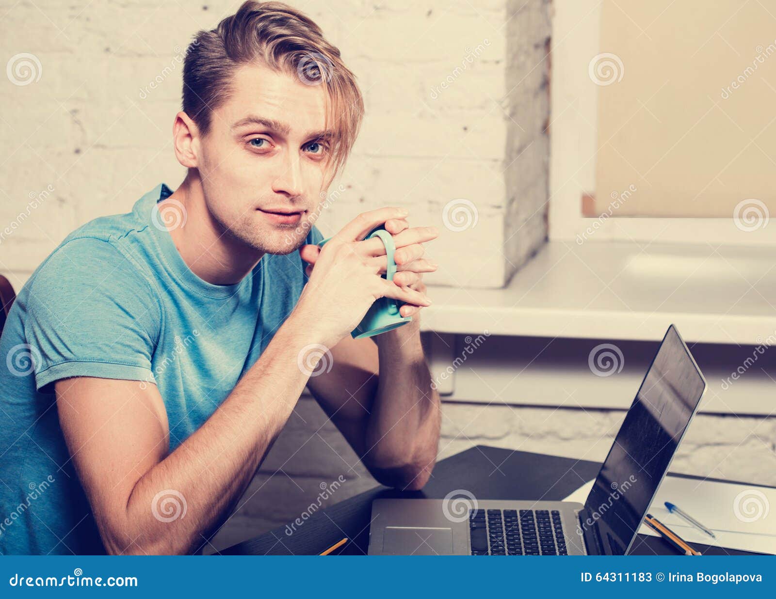 Young Man with Notebook Laptop Working on Work Place Looking Camera ...