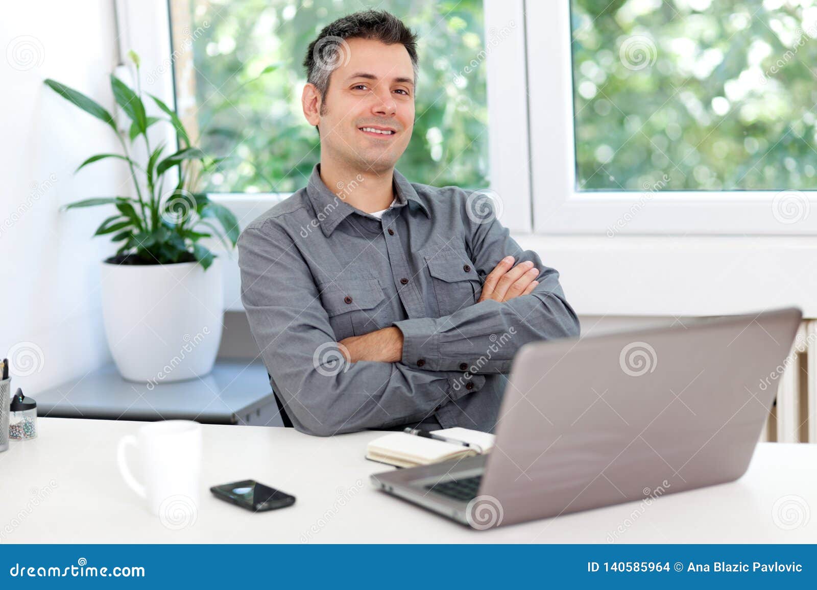 Young man at the office stock photo. Image of employee - 140585964