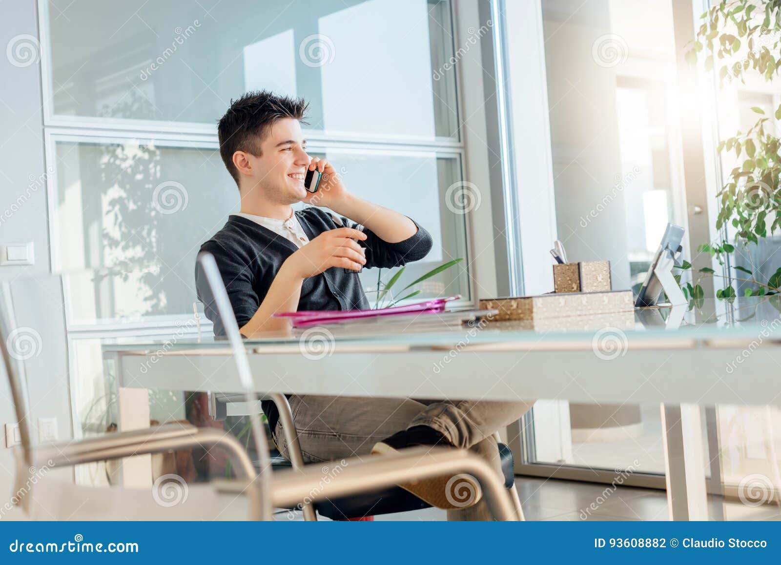 Young man in office stock photo. Image of sitting, working - 93608882