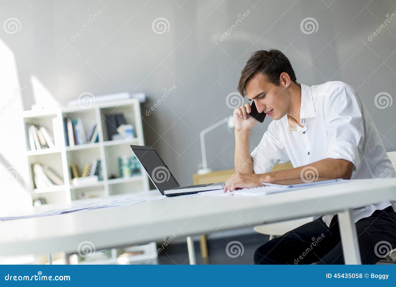 Young man in the office stock photo. Image of phonecall - 45435058