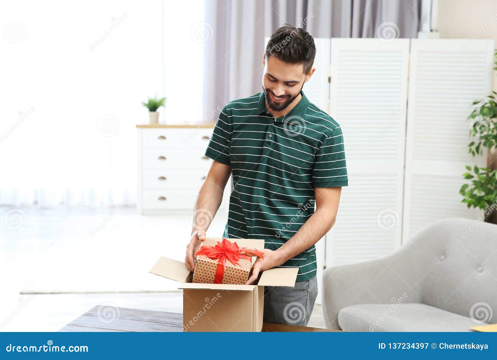 Young Man Opening Parcel on Table Stock Image - Image of postal ...