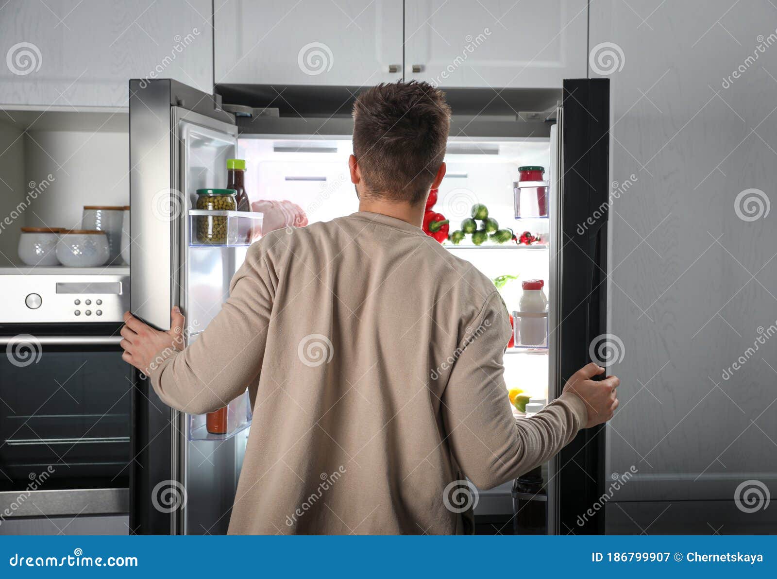 Young Man Opening Refrigerator, Back View Stock Image - Image of ...