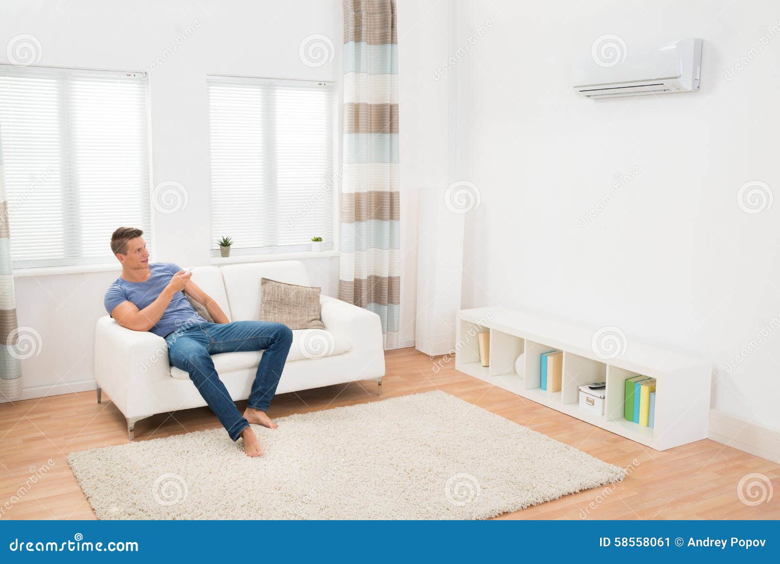 Young Man Operating Air Conditioner Stock Image - Image of conditioner ...