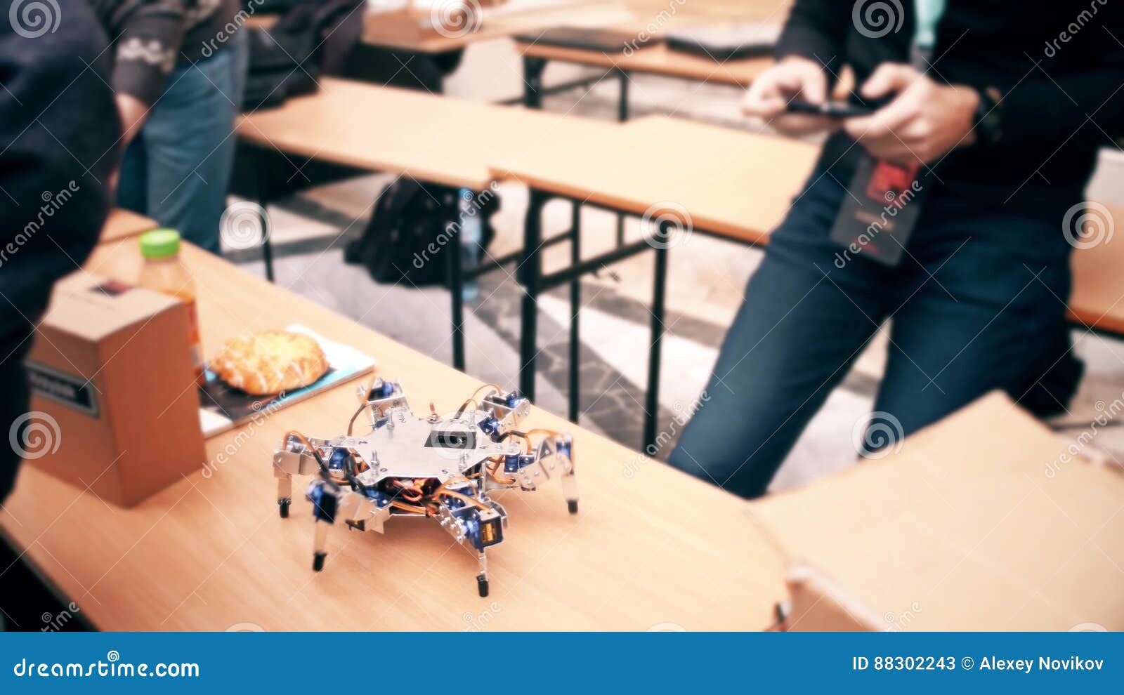 Young Man Operating His DIY Hexapod Robot Using Cell Phone Stock Image ...