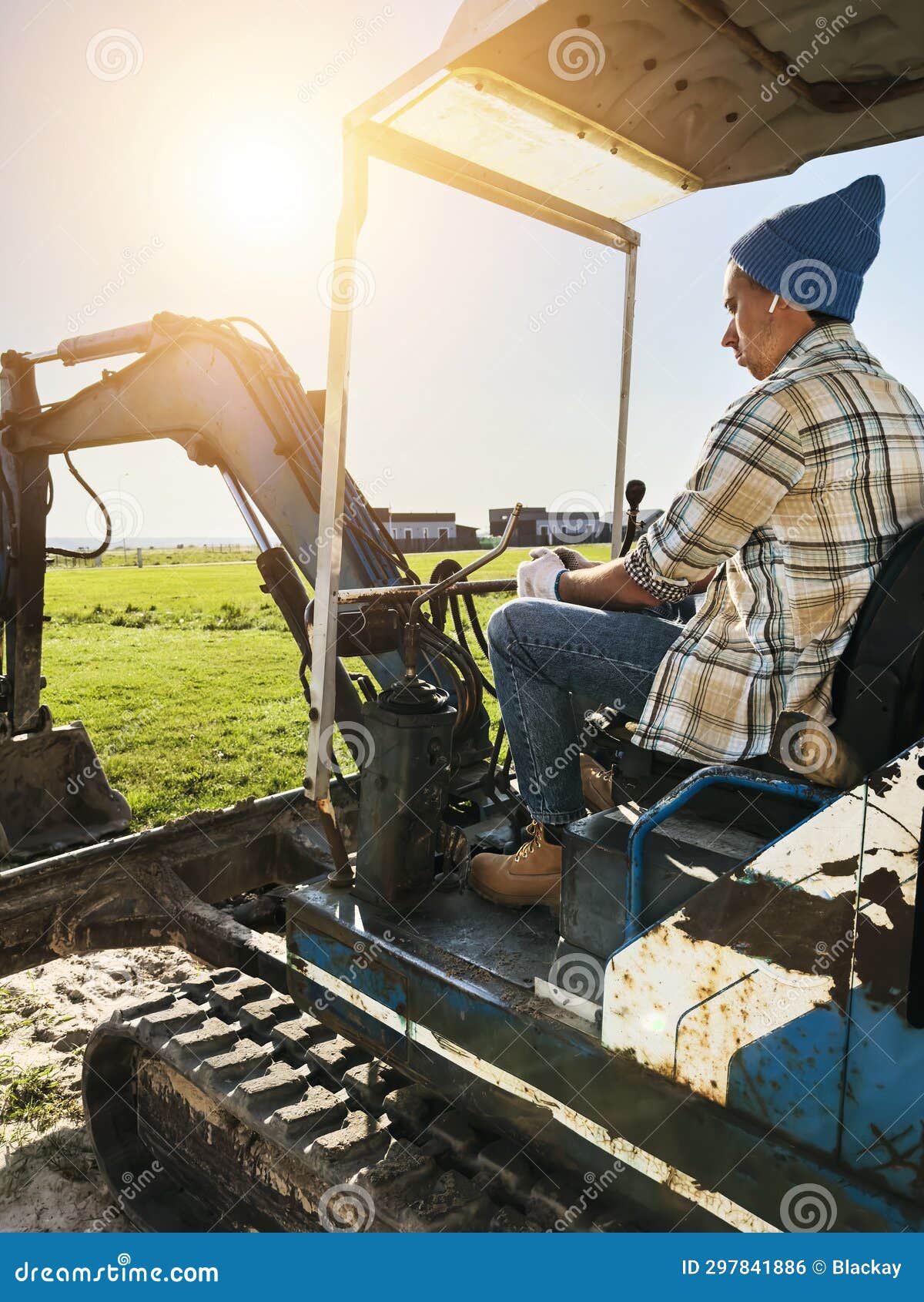 Young Man Operating His Old Excavator during His Work on a Construction ...