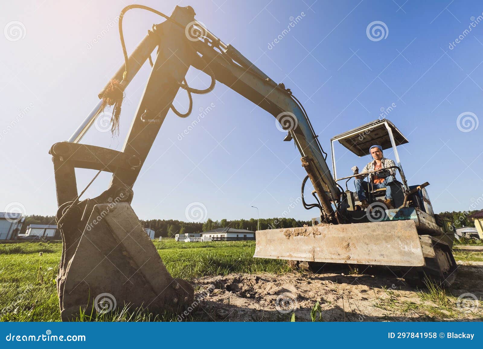 Young Man Operating His Old Excavator during His Work on a Construction ...