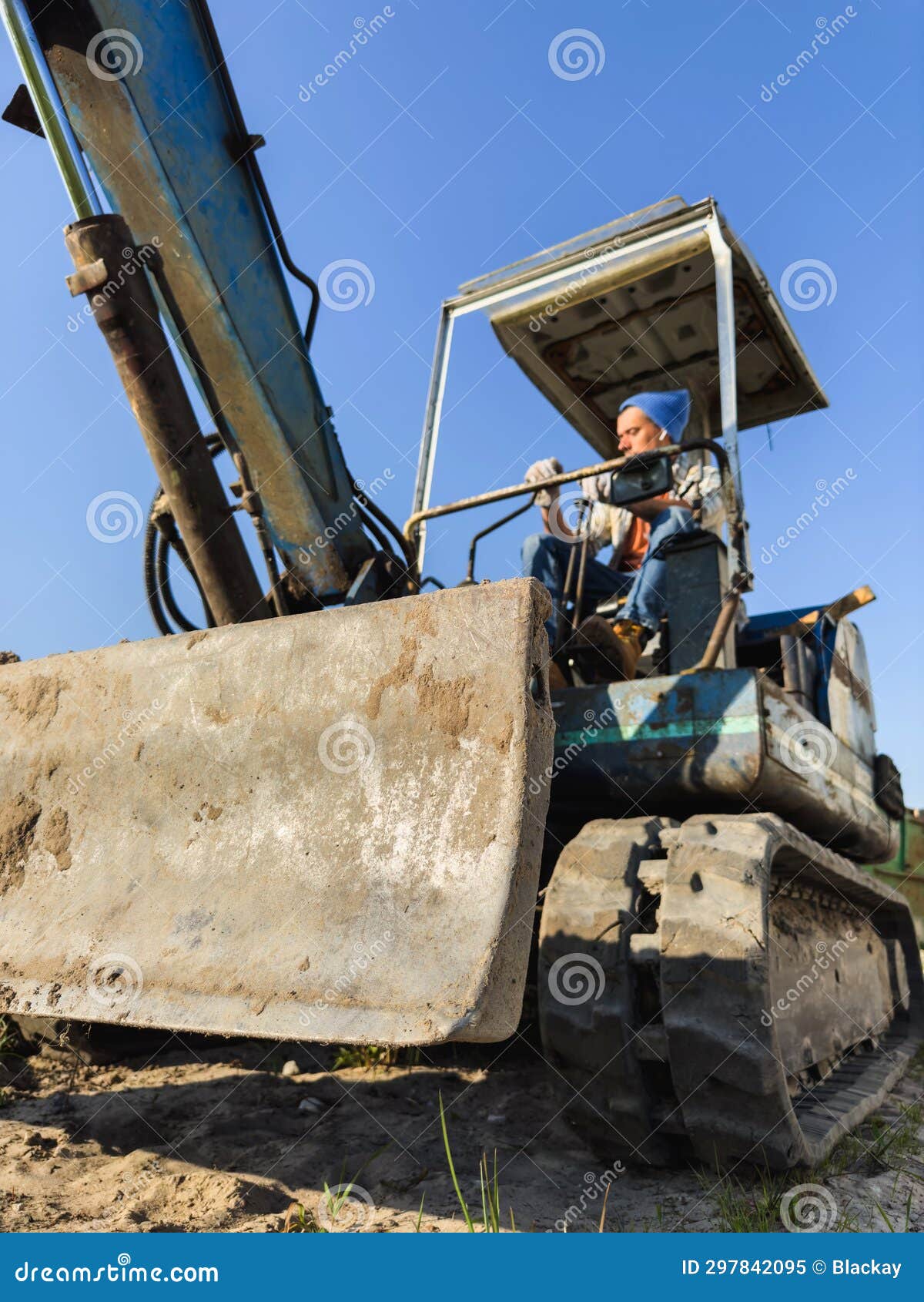 Young Man Operating His Old Excavator during His Work on a Construction ...