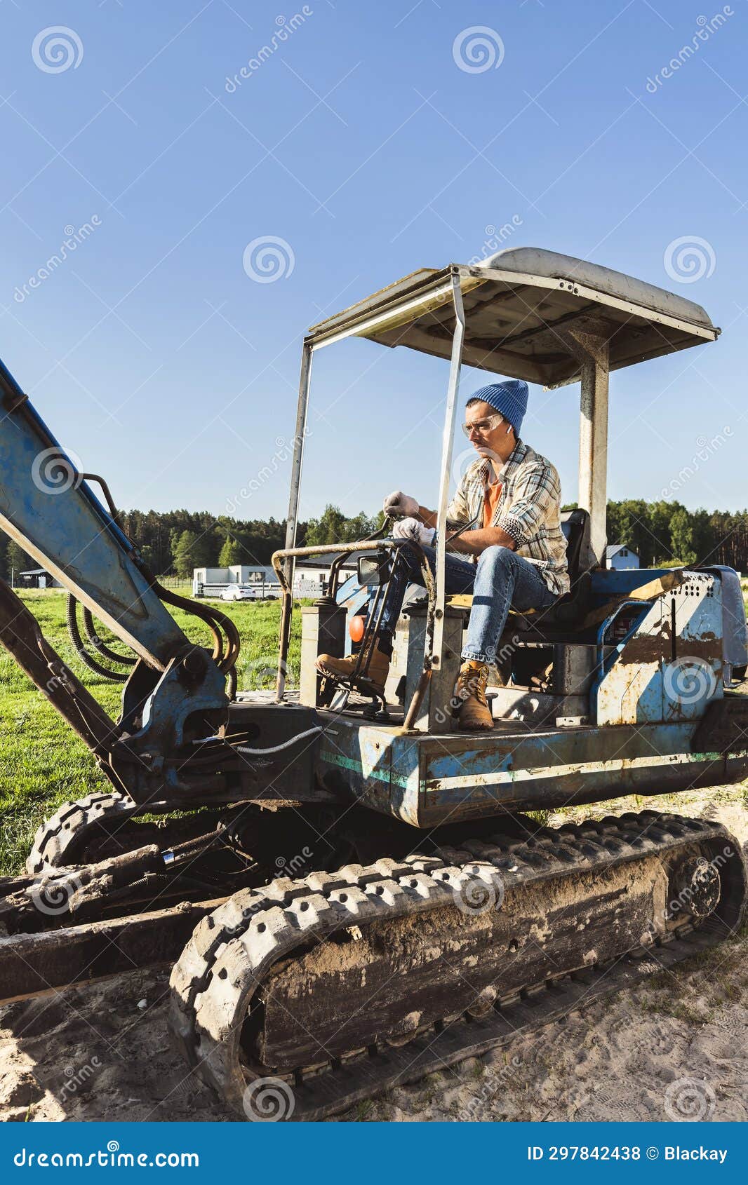 Young Man Operating His Old Excavator during His Work on a Construction ...