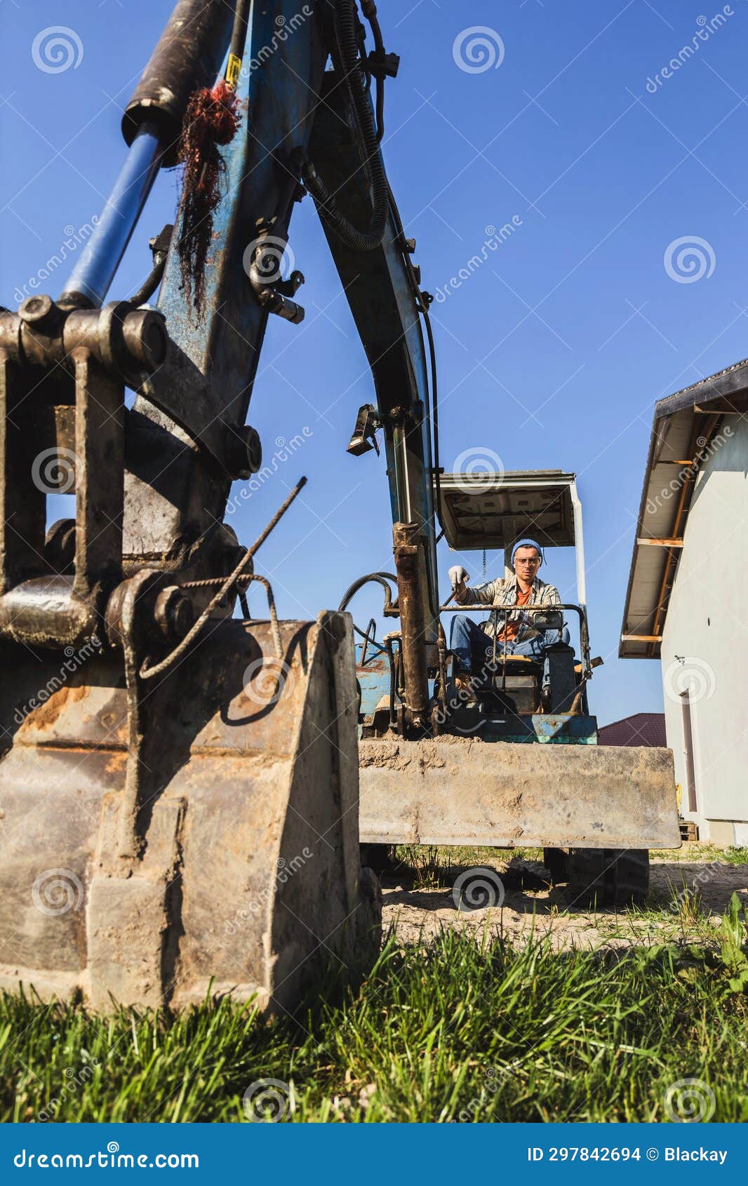 Young Man Operating His Old Excavator during His Work on a Construction ...