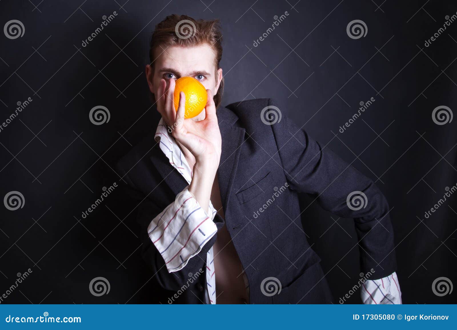 Young Man with an Orange in His Hand Stock Photo - Image of pose ...
