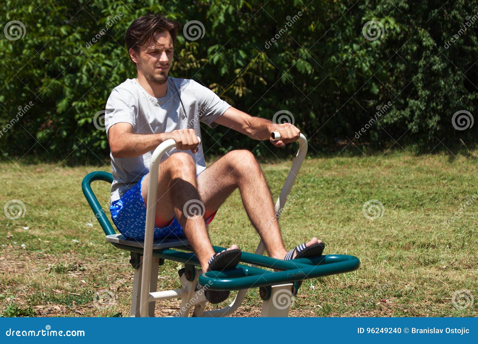 Young Man Outdor Exercise on Rowing Machine Stock Photo - Image of ...