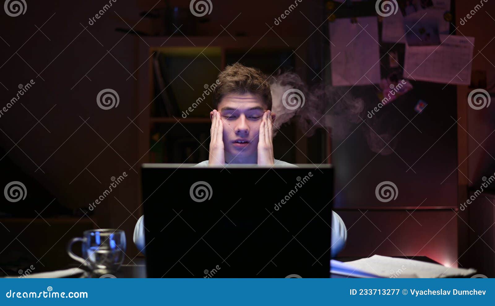 Smoke Comes from a Young Guy Who Works at a Computer in the Middle of ...