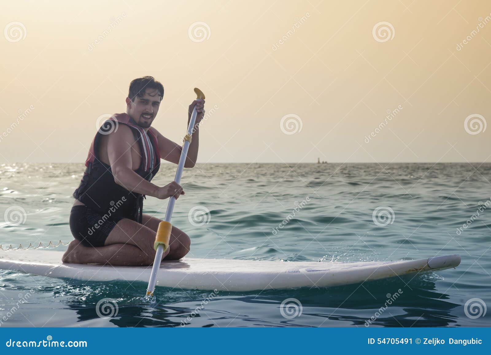 Young Man Paddleboarding stock image. Image of activity - 54705491