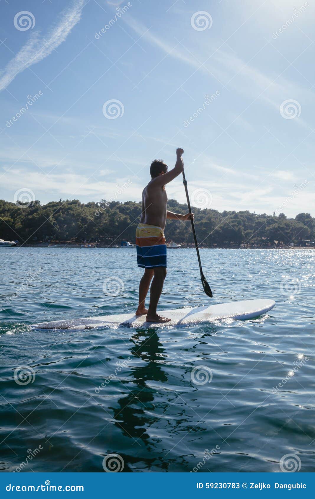 Young Man Paddleboarding stock image. Image of destinations - 59230783