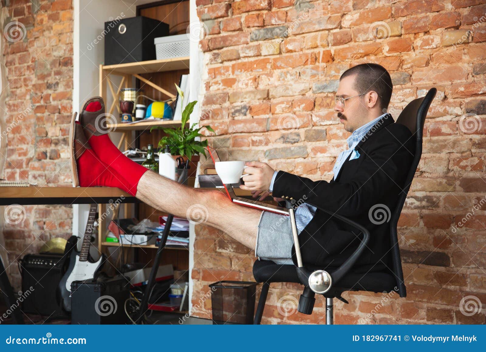 Young Man without Pants but in Jacket Working on a Computer, Laptop ...