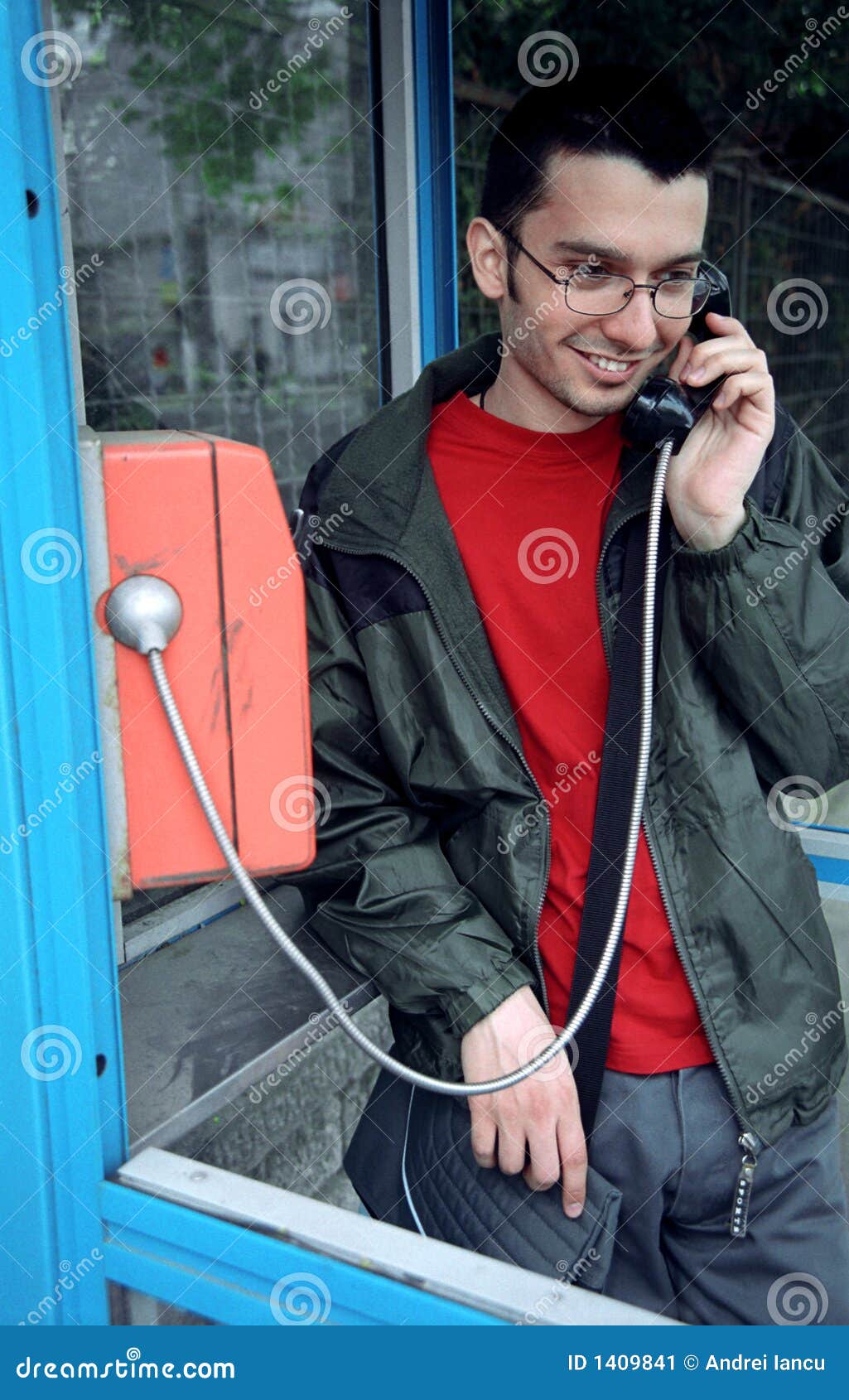 Young man on payphone stock image. Image of male, casual - 1409841