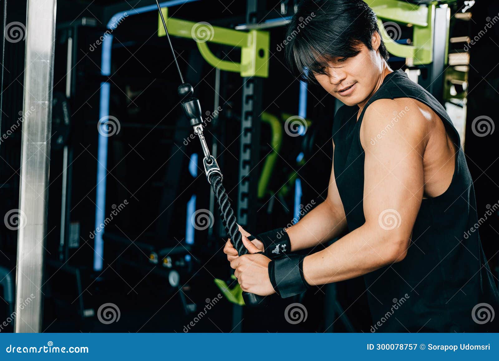Young Man Performing Cable Triceps Pulldowns To Build Muscle and ...