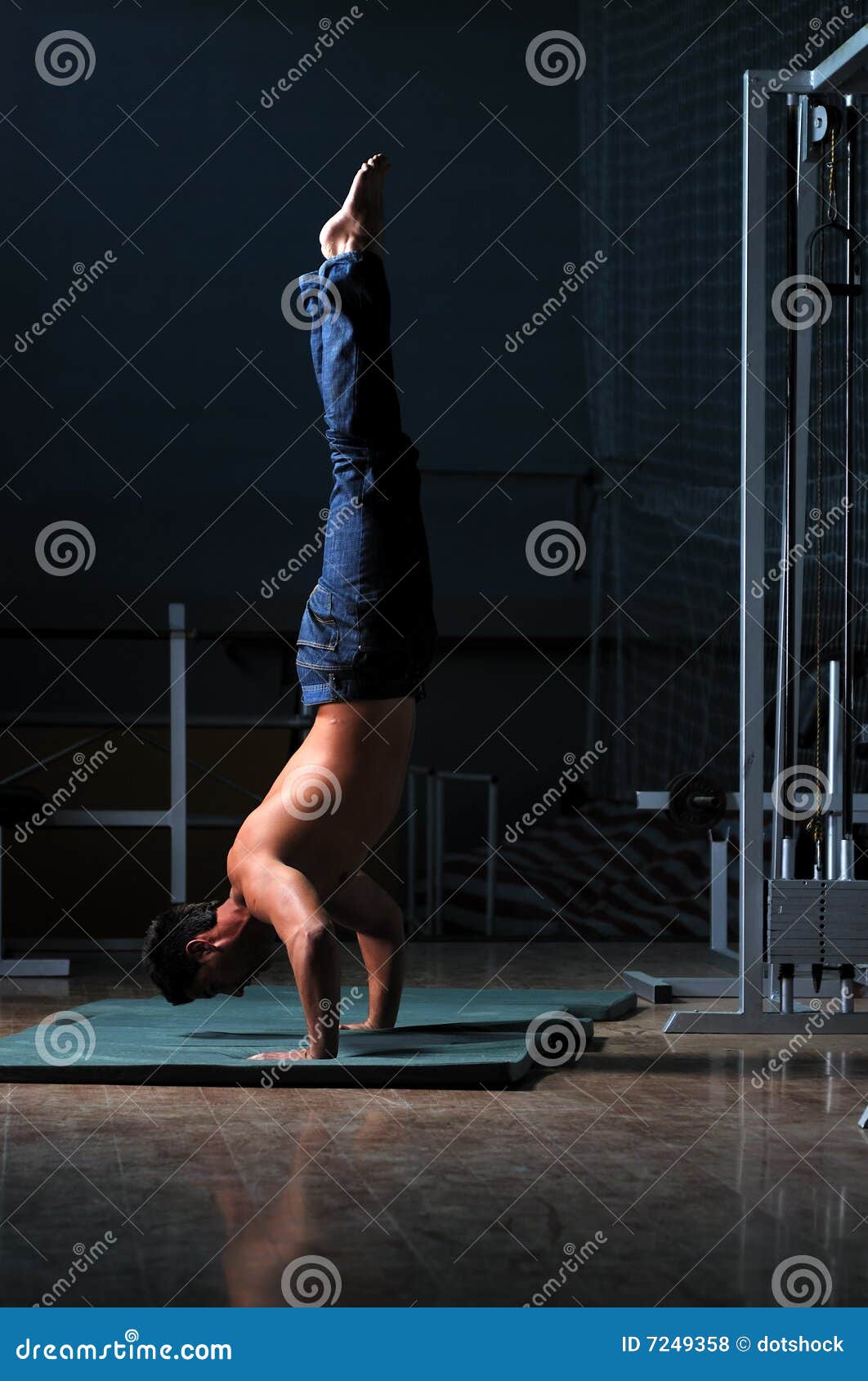 Young Man Performing Handstand in Fitness Studio Stock Photo - Image of ...