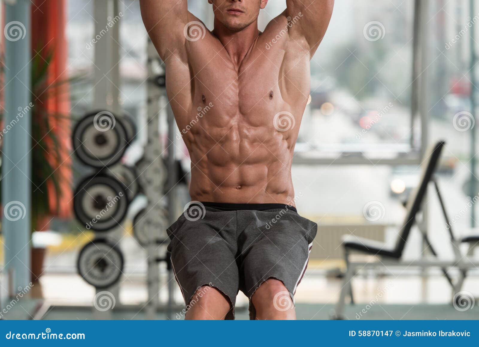 Young Man Performing Hanging Leg Raises Abs Exercise Stock Image ...