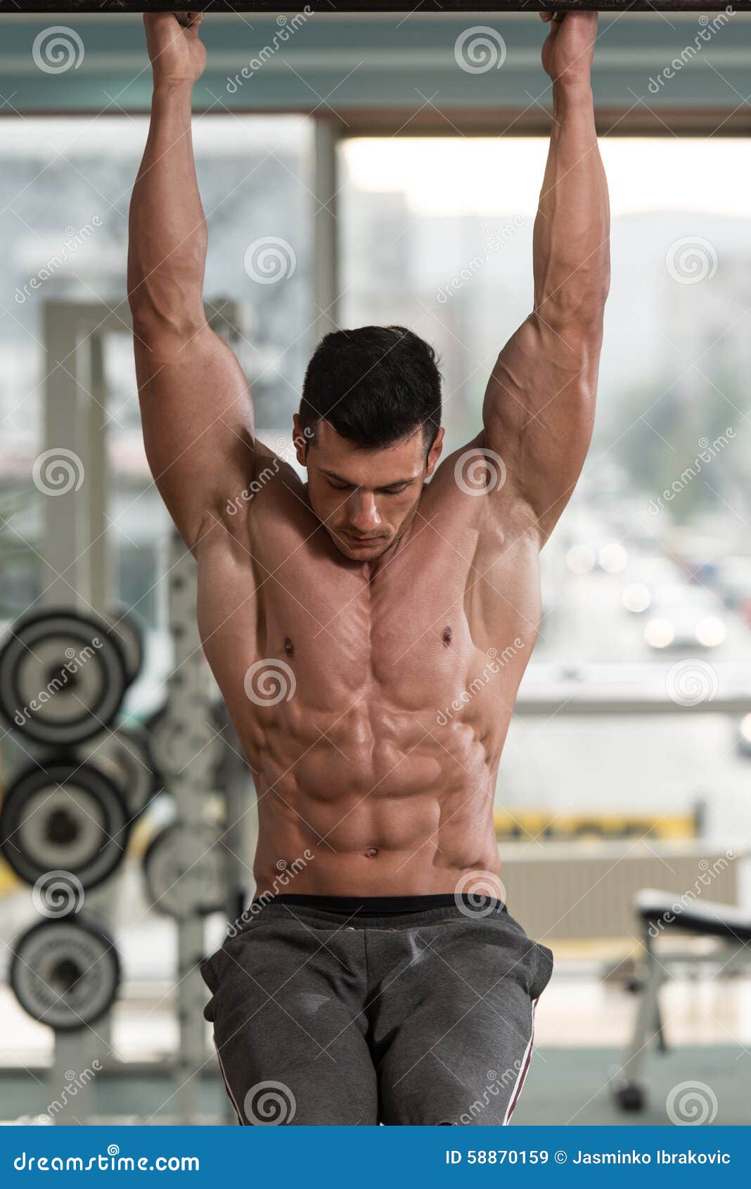 Young Man Performing Hanging Leg Raises Abs Exercise Stock Image ...