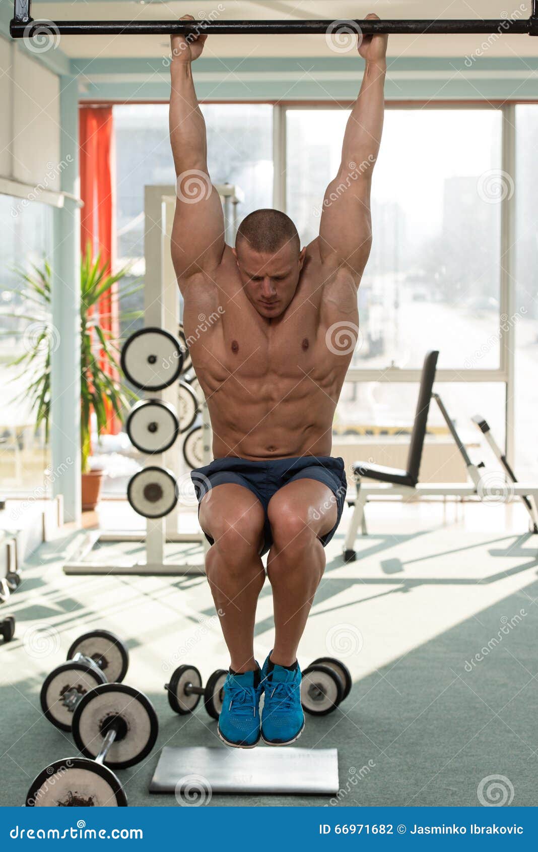 Young Man Performing Hanging Leg Raises Abs Exercise Stock Photo ...
