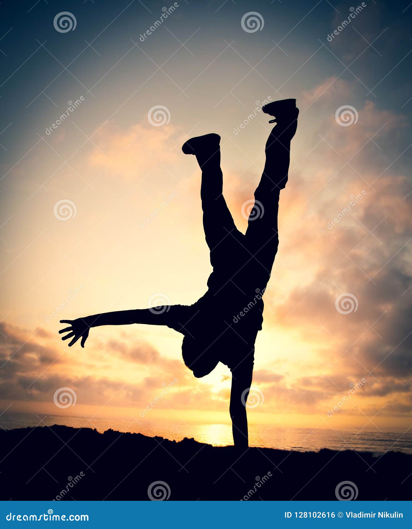 Young Man Performs Acrobatics on the Beach Stock Photo - Image of beach ...