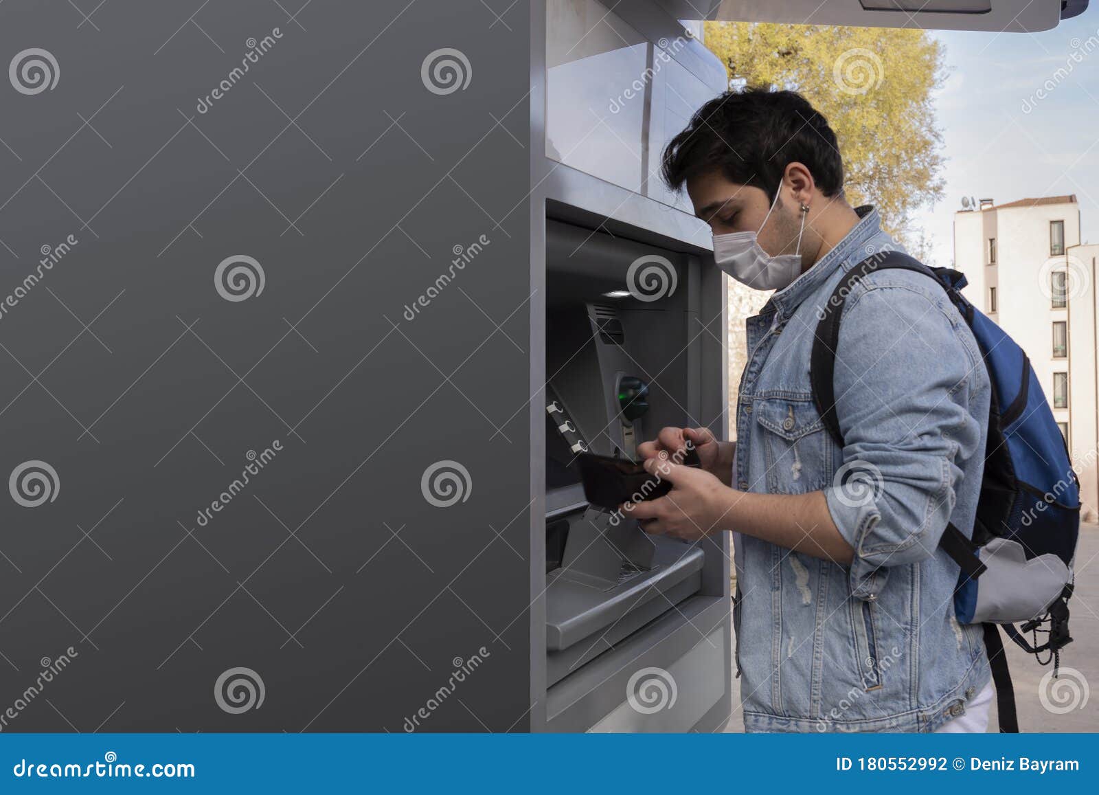 The Young Man Performs His Transactions from the Bank Atm Using His ...