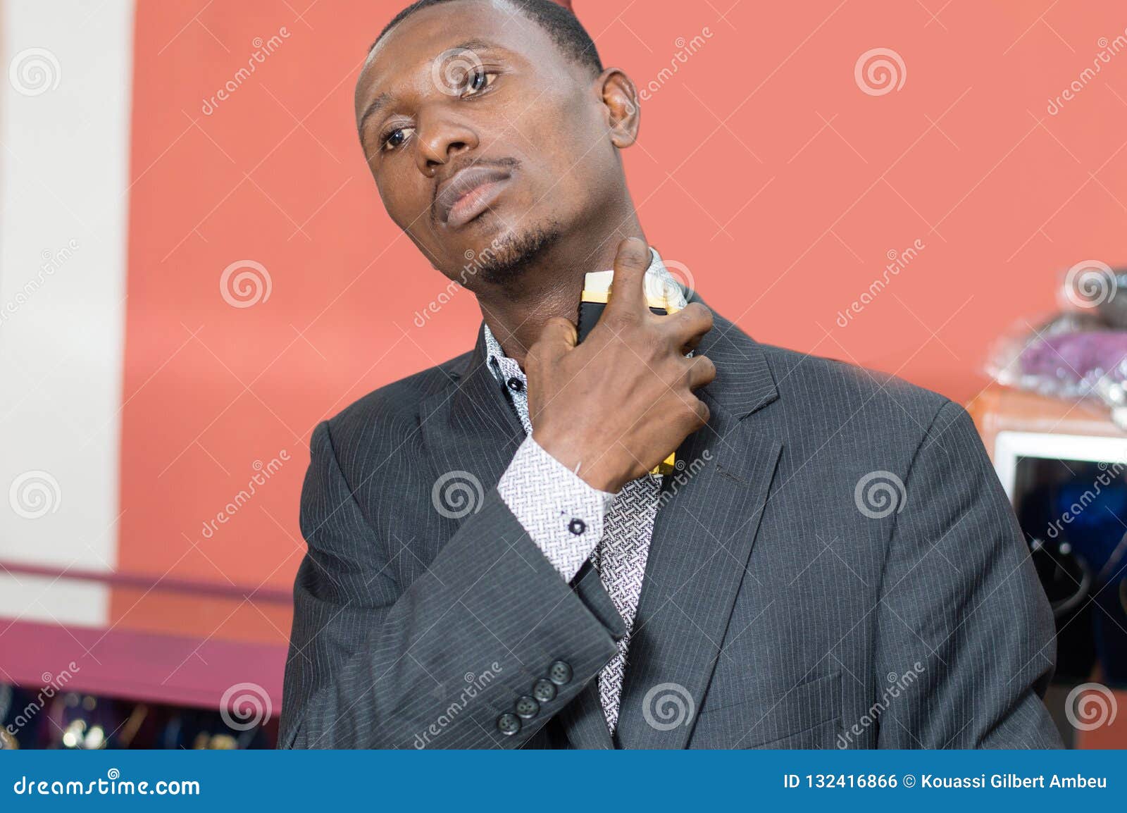 Young man perfuming stock photo. Image of holding, cosmetic - 132416866