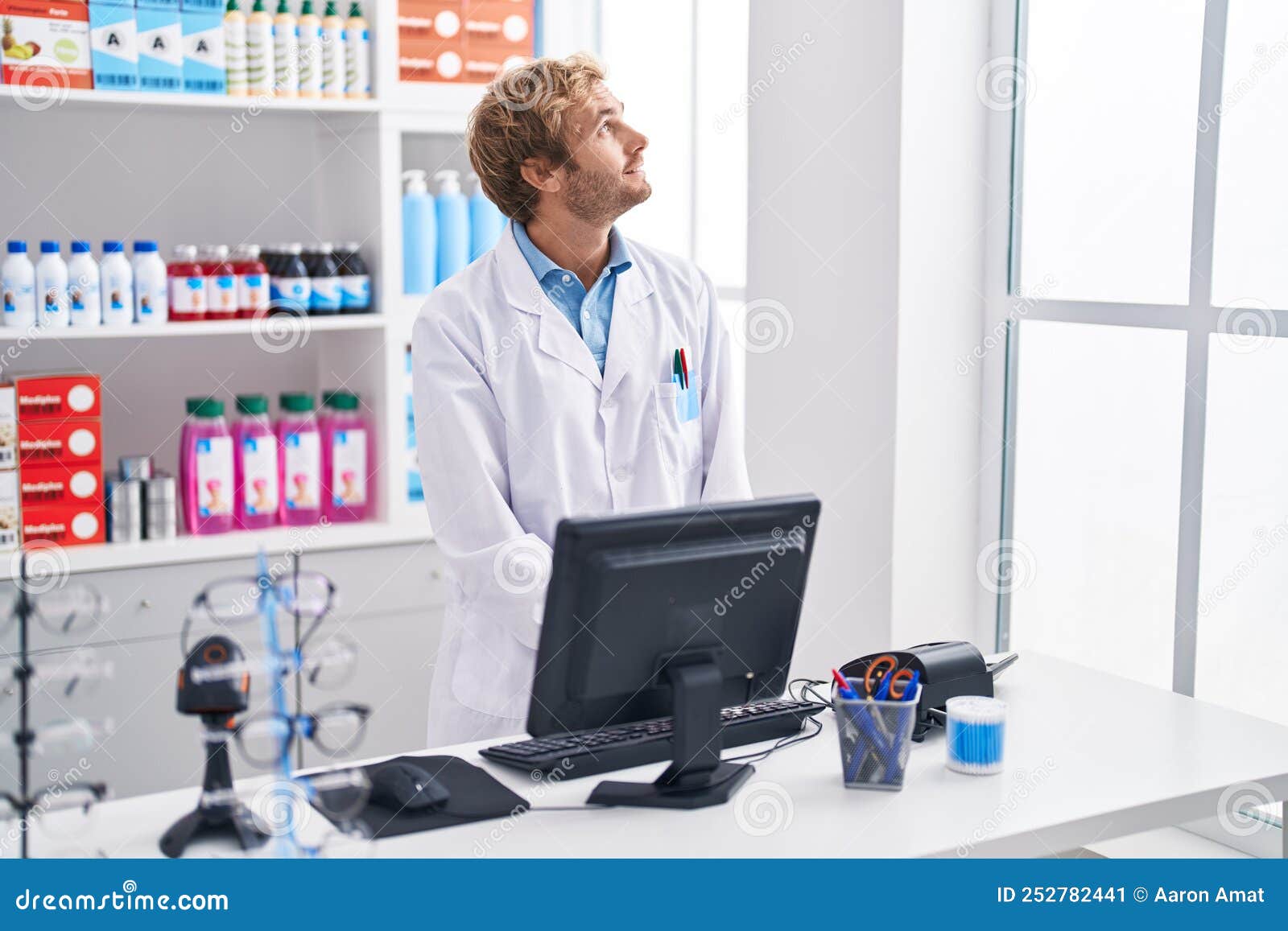 Young Man Pharmacist Using Computer Working at Pharmacy Stock Image ...