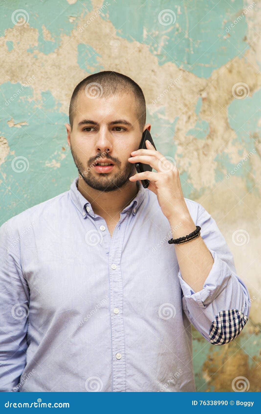 Young man with phone stock photo. Image of beard, standing - 76338990