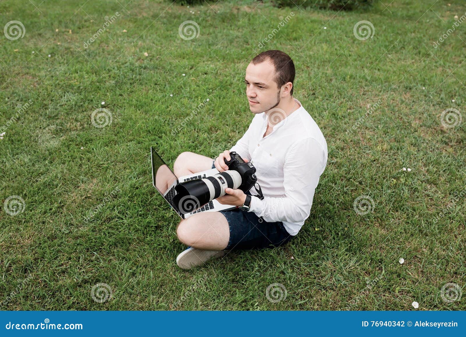 Young Man Photographer Using Laptop and Camera in the Park Stock Photo ...