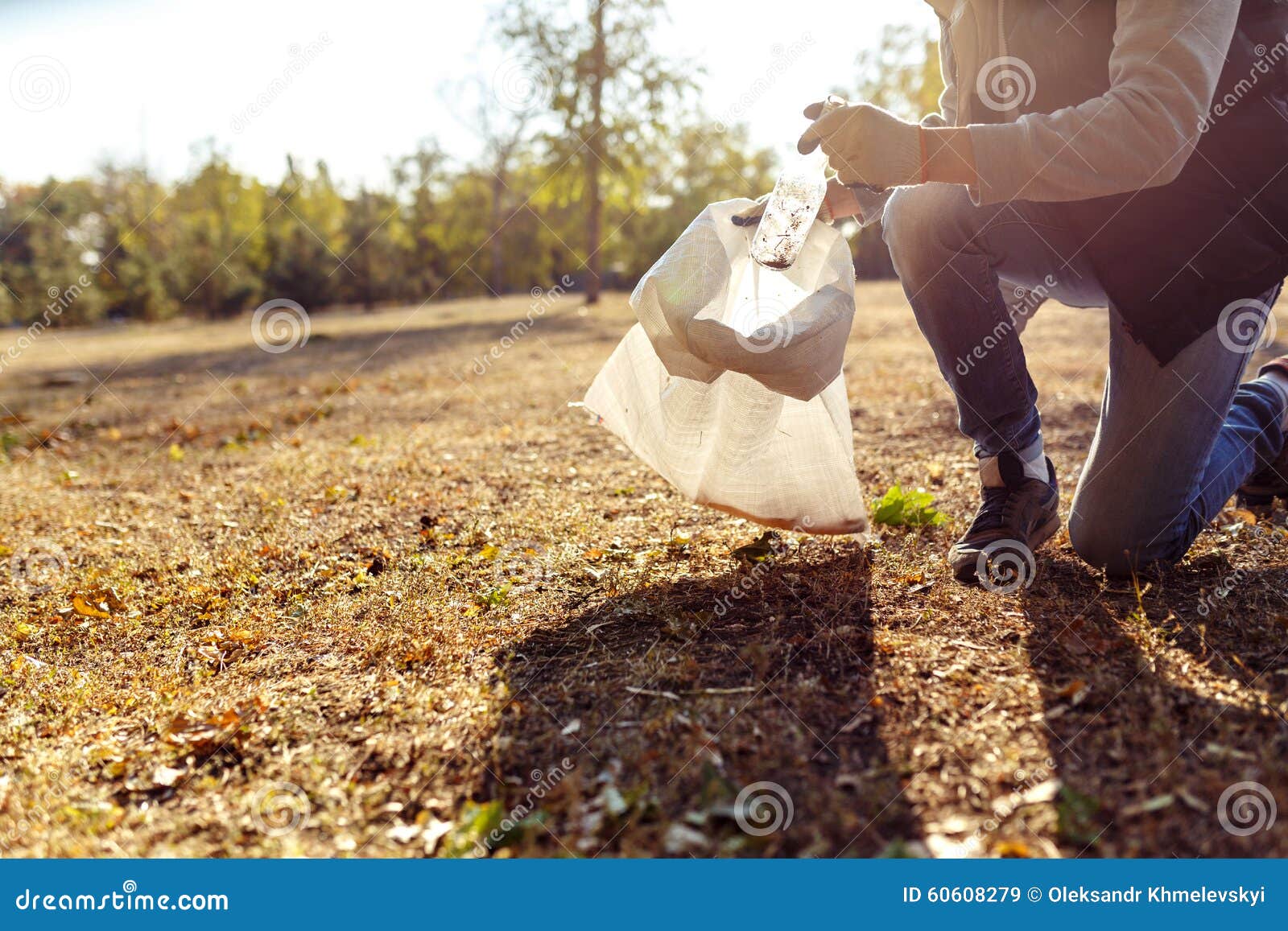 Young man picking up trash stock image. Image of community - 60608279