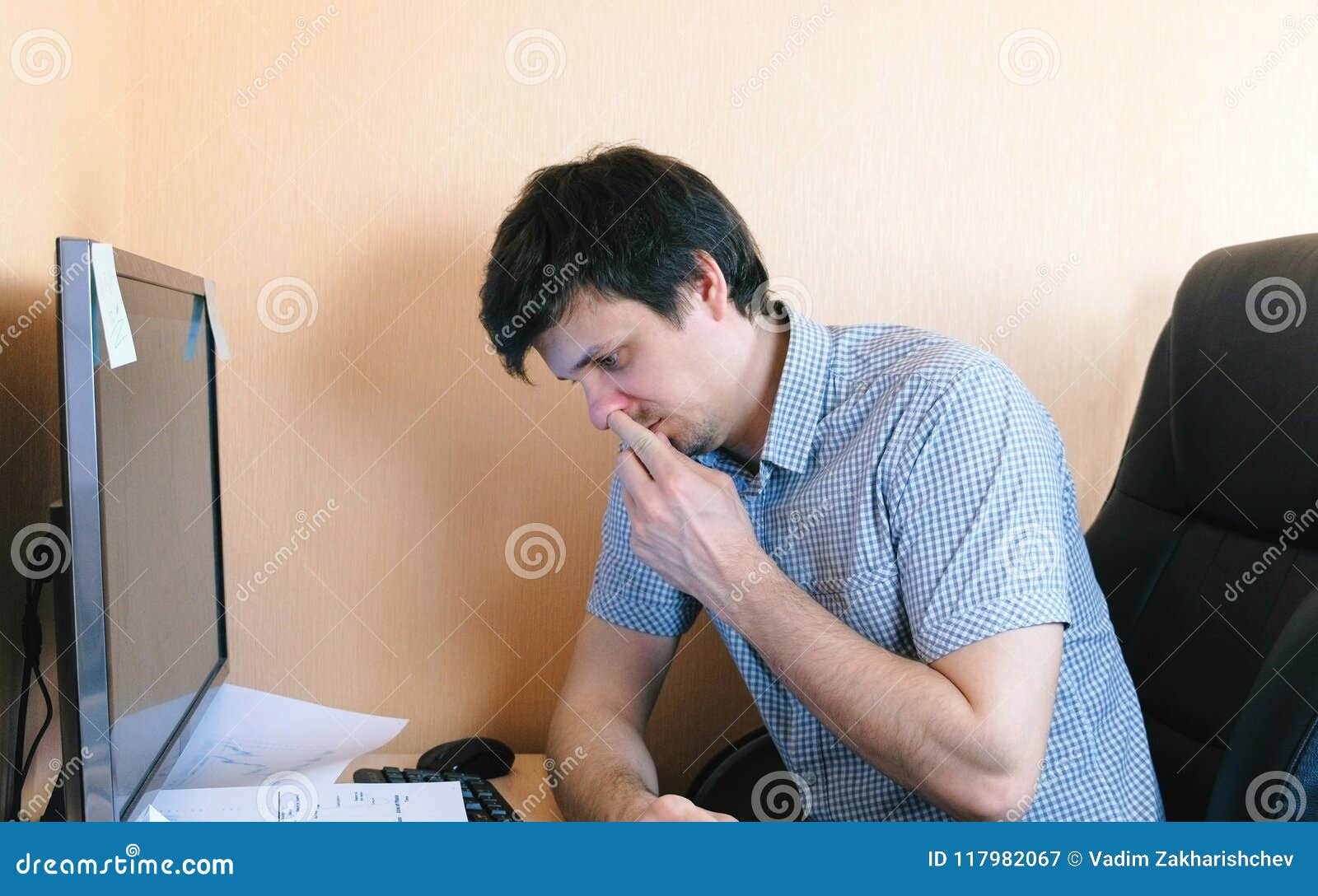 Young Man Picks His Nose Working at the Computer. Stock Image - Image ...