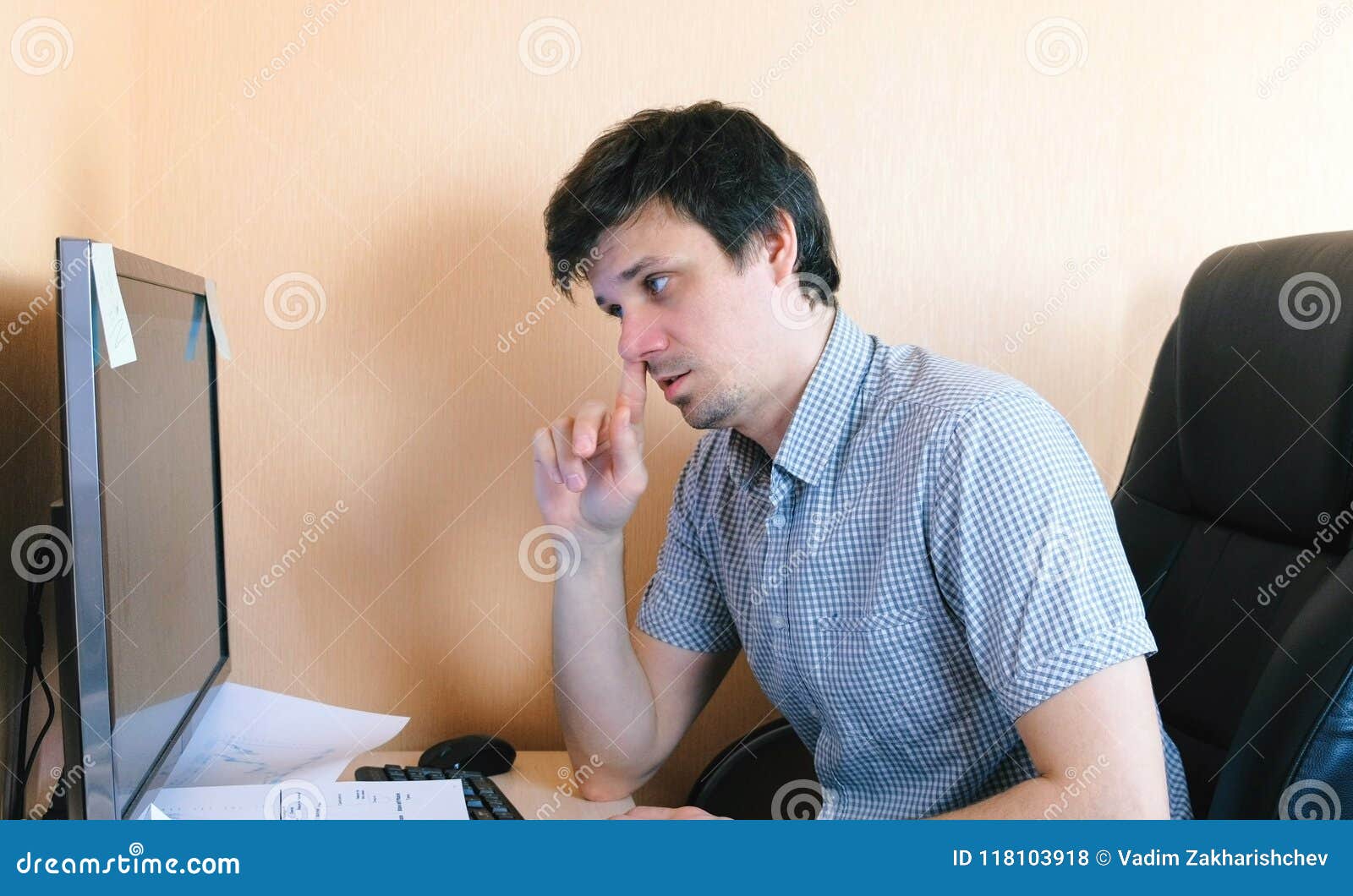 Young Man Picks His Nose Working at the Computer. Stock Photo - Image ...
